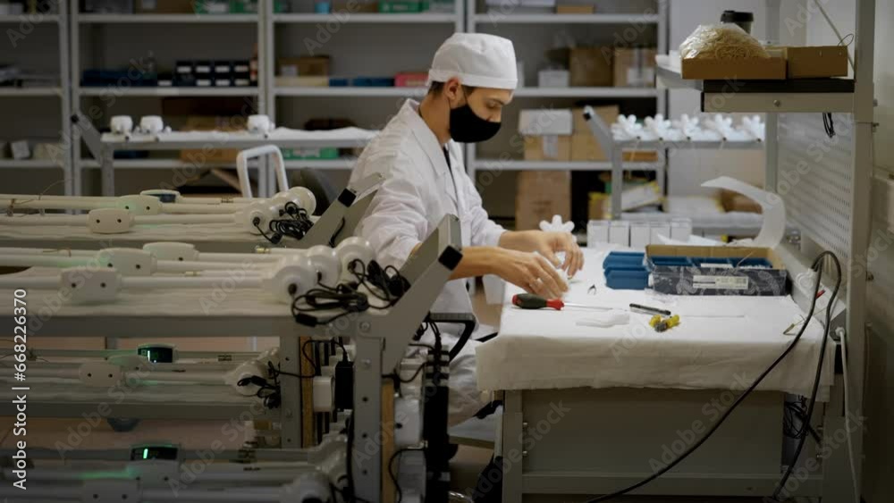 Inside A Production Room. Trolleys With Medical Lamps. Man Fixing the ...