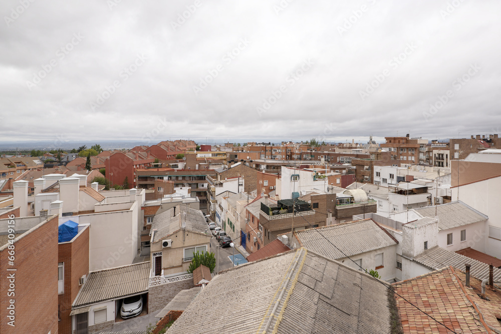 View of a town with low-rise buildings with clay tile and fiber cement ...