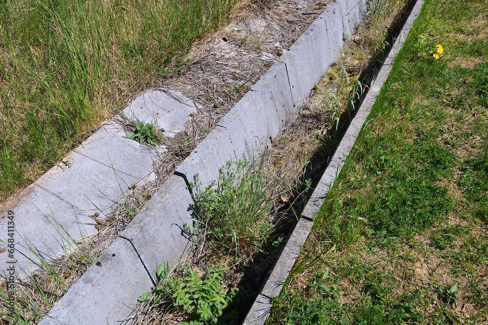 Trough , drainage of sewage outflow overgrown in grass Stock Photo ...