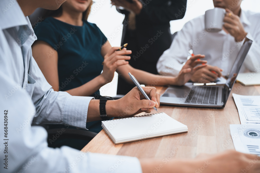 Secretary taking notes on notebook at corporate meeting with group of ...