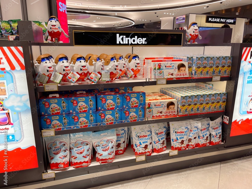 Brand Kinder products on shelves. Racks with Kinder sweets in grocery ...