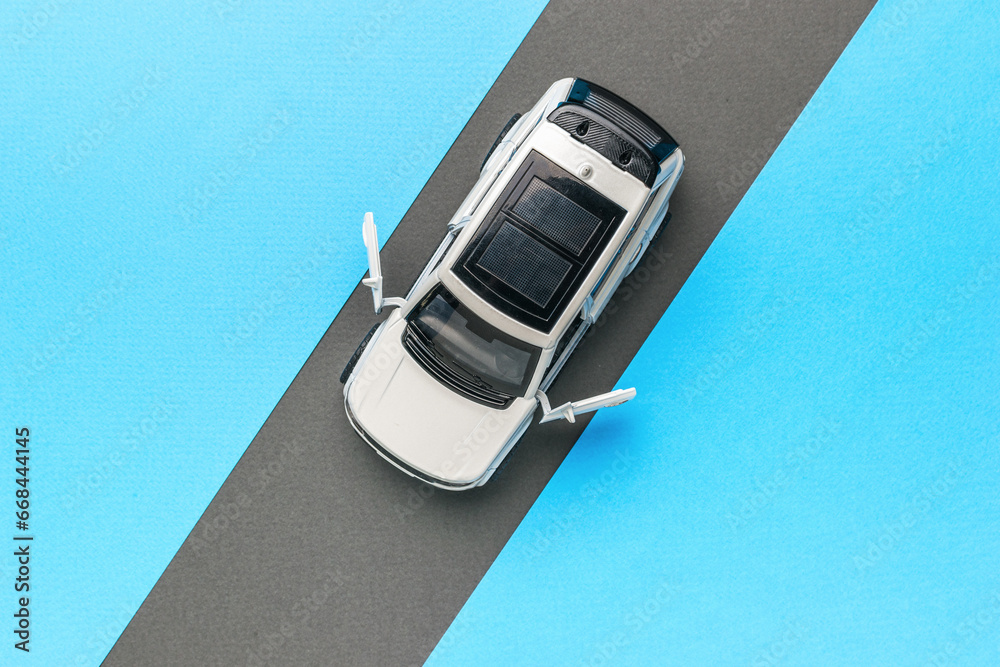 Top view of a white car with open doors on a gray road. The concept of ...