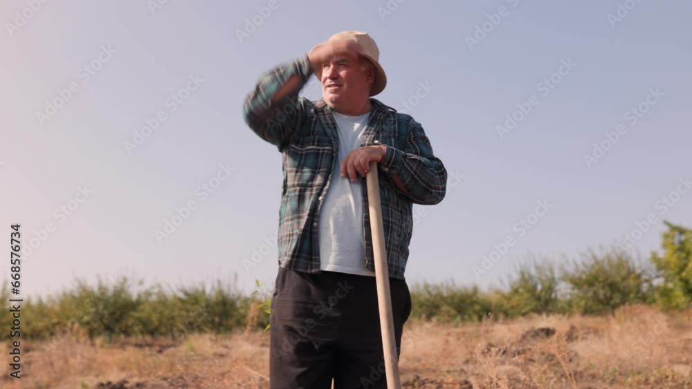 4K Real People, Real Work. A Seasoned Farmer Stands Proudly in the ...