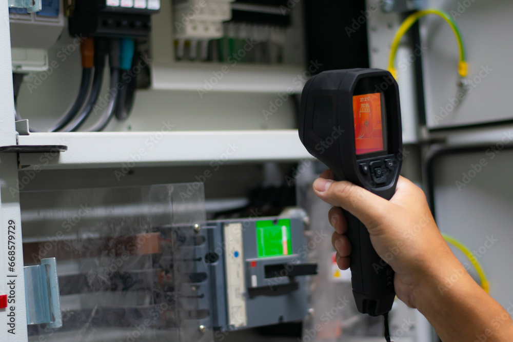 Professional Electrician use thermal infrared camera or thermometer ...