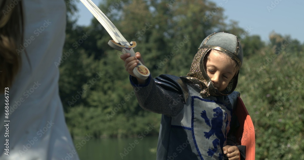 Children playing with swords and shields - young boy wearing medieval ...