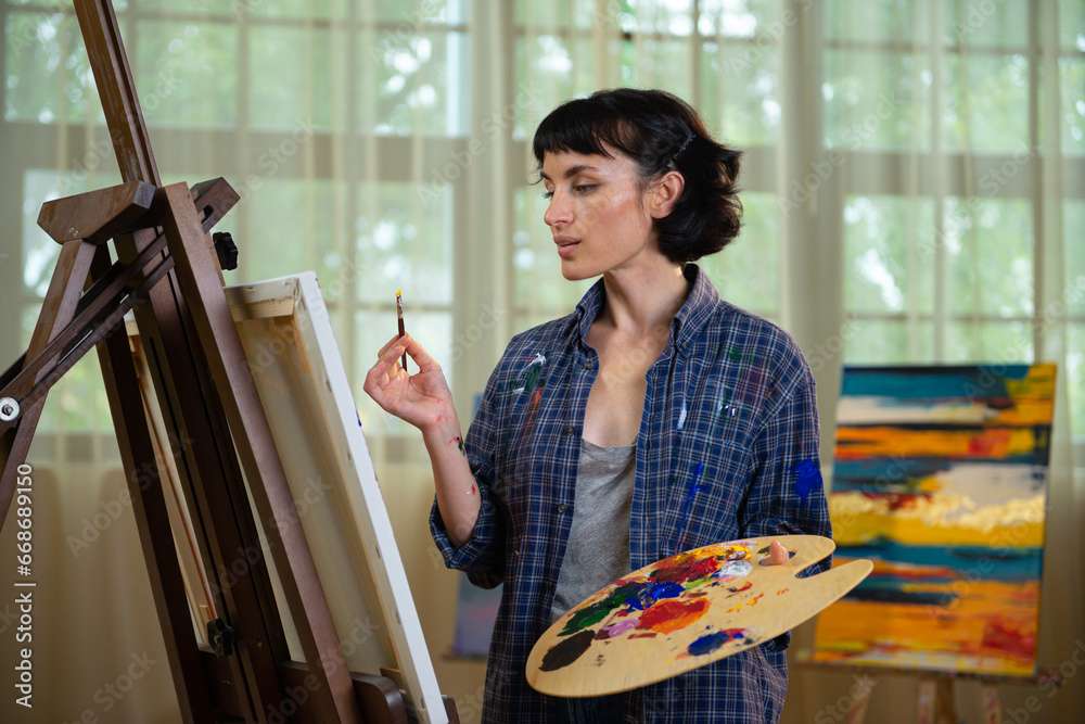 Bringing her creativity to life. Woman painting in her art studio Stock ...