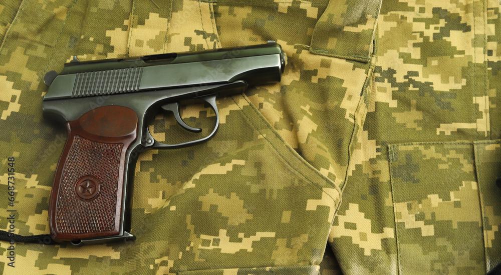 Firearms on military uniform. Top view of a gun with bullets. Military ...