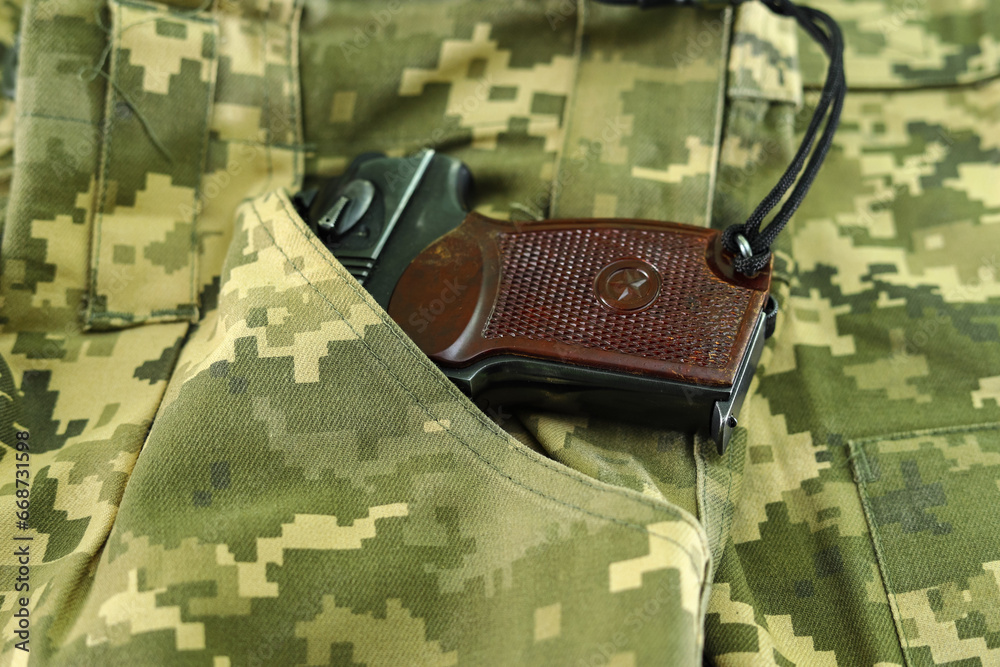 Firearms on military uniform. Top view of a gun with bullets. Military ...