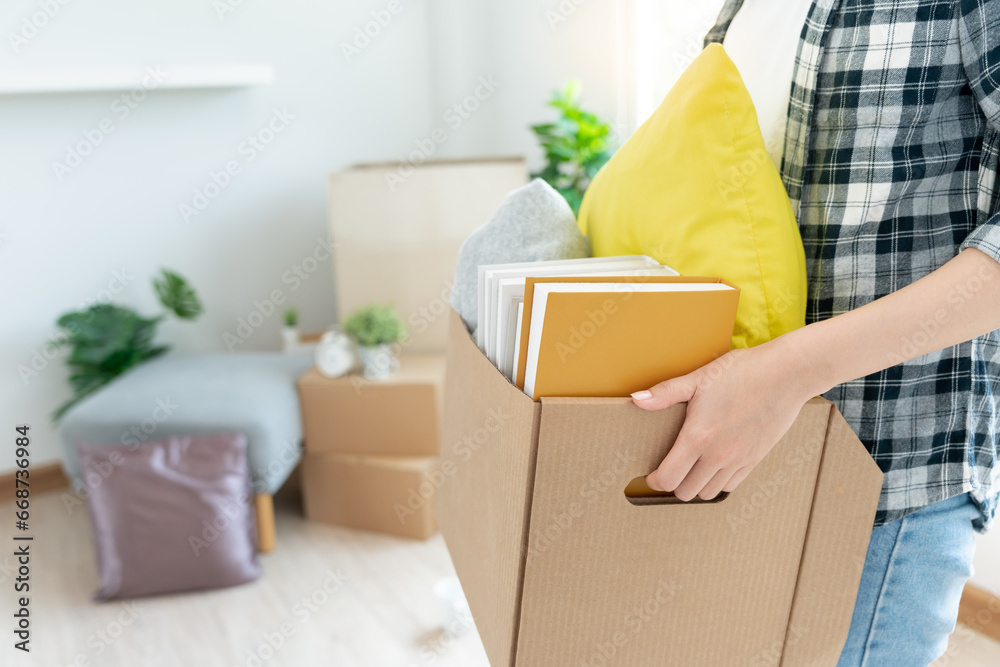 Moving house, relocation. Woman hold carton box contain equipment for ...