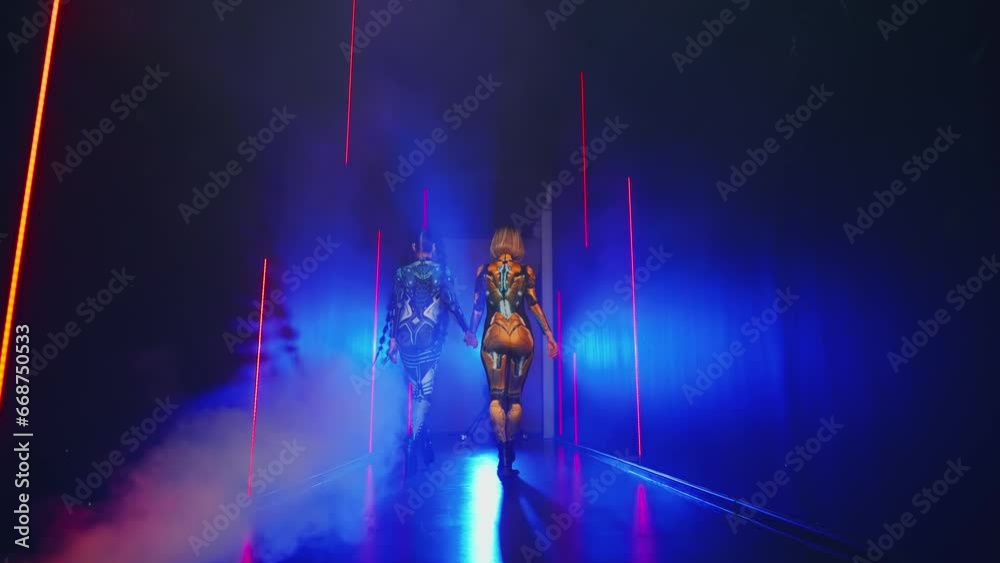 Two women walks studio full smoke, Fantasy cyborg woman robot costume ...
