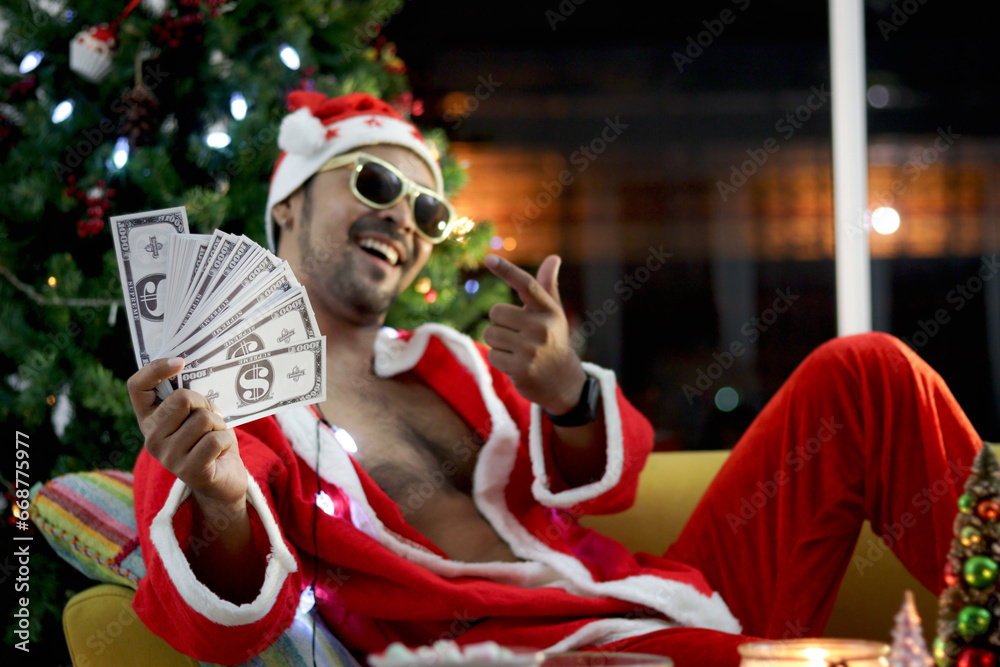Happy young man in Santa Claus costume lying on sofa, Sexy attractive ...