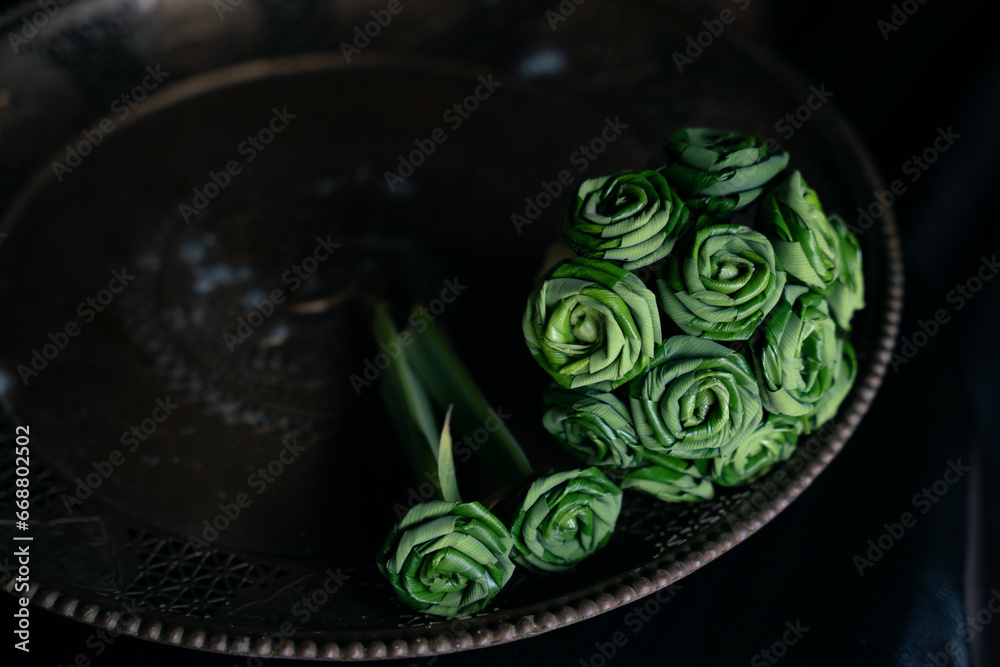 Green flowers that are folded using pandan leaves to worship the gods ...