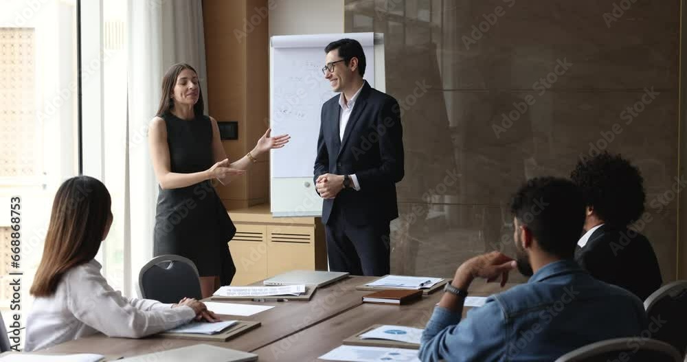 Middle-aged female leader welcoming new male employee, shake hands ...