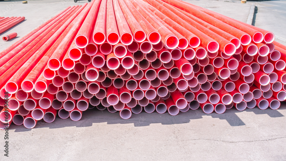 Red polyvinyl chloride pipes for laying electrical cables. Plastic pipe ...