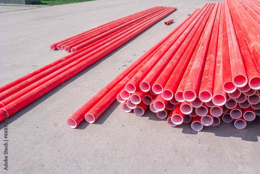Red polyvinyl chloride pipes for laying electrical cables. Plastic pipe ...