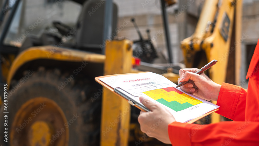 The operation supervisor is using ballpoint pen to marking on the risk ...