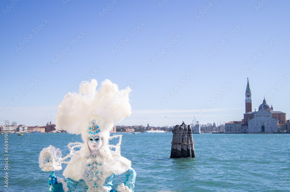 Ethereal Venetian figure in white and aqua ensemble with majestic ...