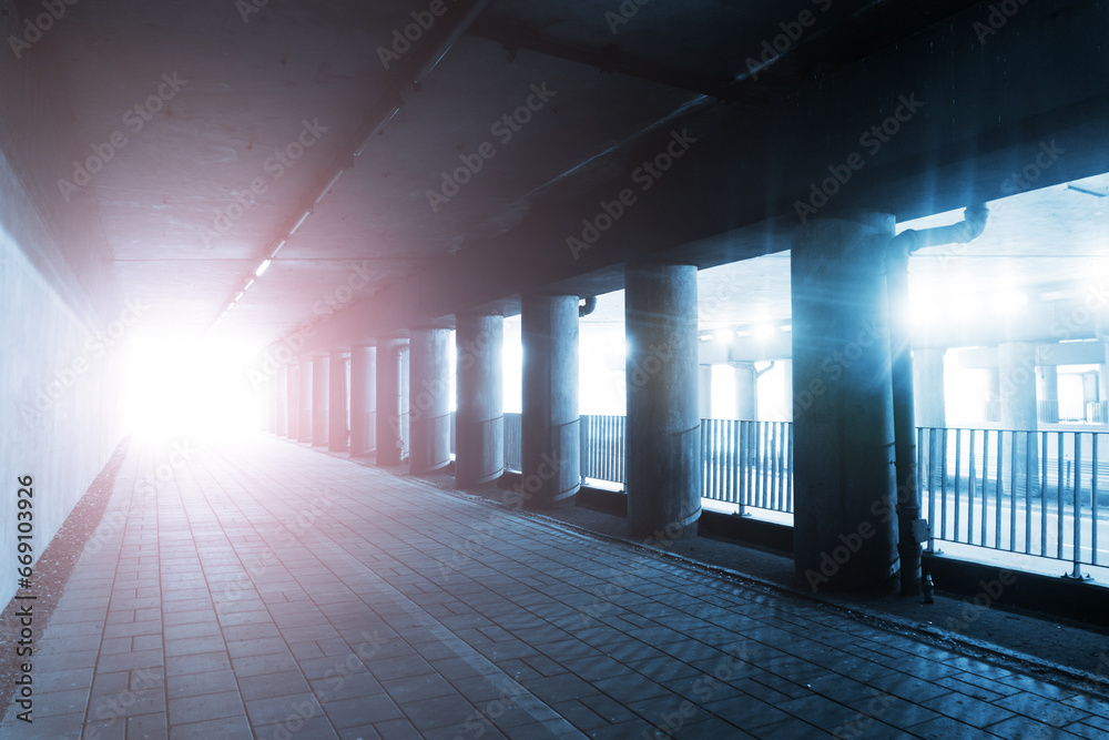 Horror tunnel background. Dark pavement tunnel with bright light at the ...
