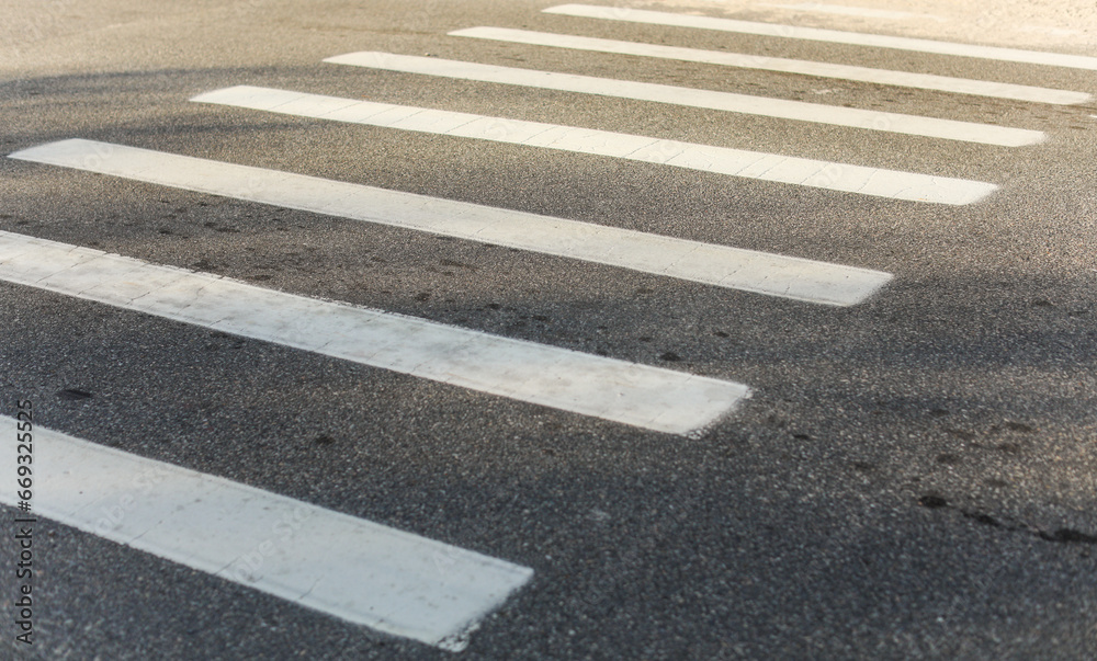 crosswalk on urban street, painted white lines symbolize safety and ...