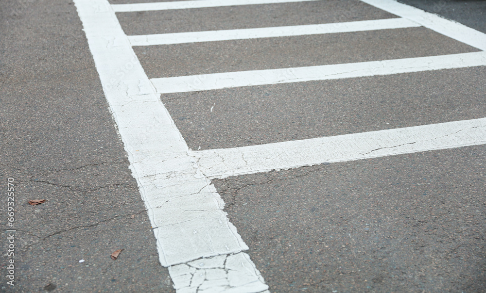 crosswalk on urban street, painted white lines symbolize safety and ...