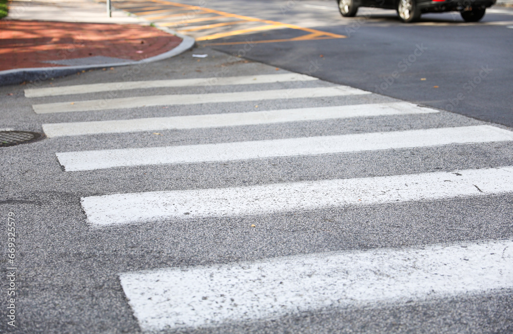 crosswalk on urban street, painted white lines symbolize safety and ...