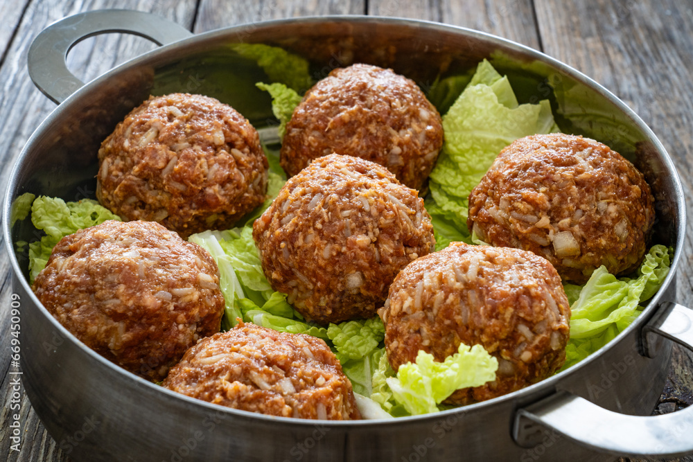 Lion's head meatballs - uncooked big meatballs with vegetables in stem ...