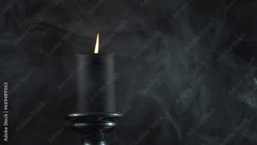 Candlelight in the shadows. A single candle located on a candlestick ...