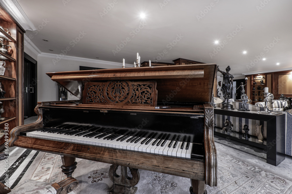 Beautiful varnished wooden grand piano in a living room with saturated ...