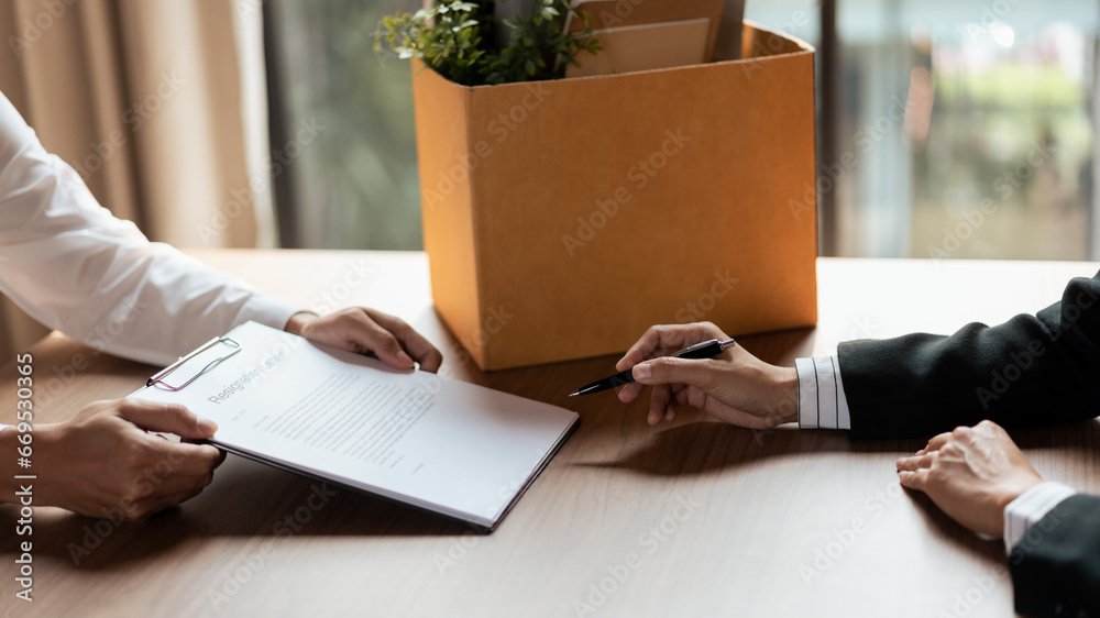 Executive signing on resignation letter for male employee when quitting ...