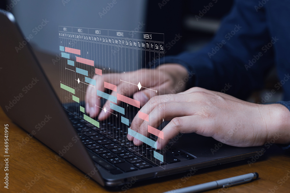 Business Planning and Schedule Plan table on screen with people working ...