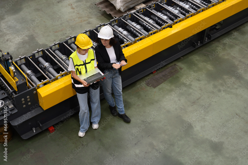 Top view of industrial executive and factory worker wearing hard hat ...