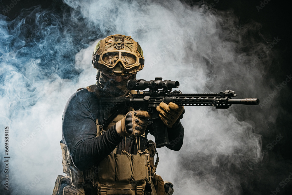 Portrait of a special forces soldier aiming at the collimator sight of ...