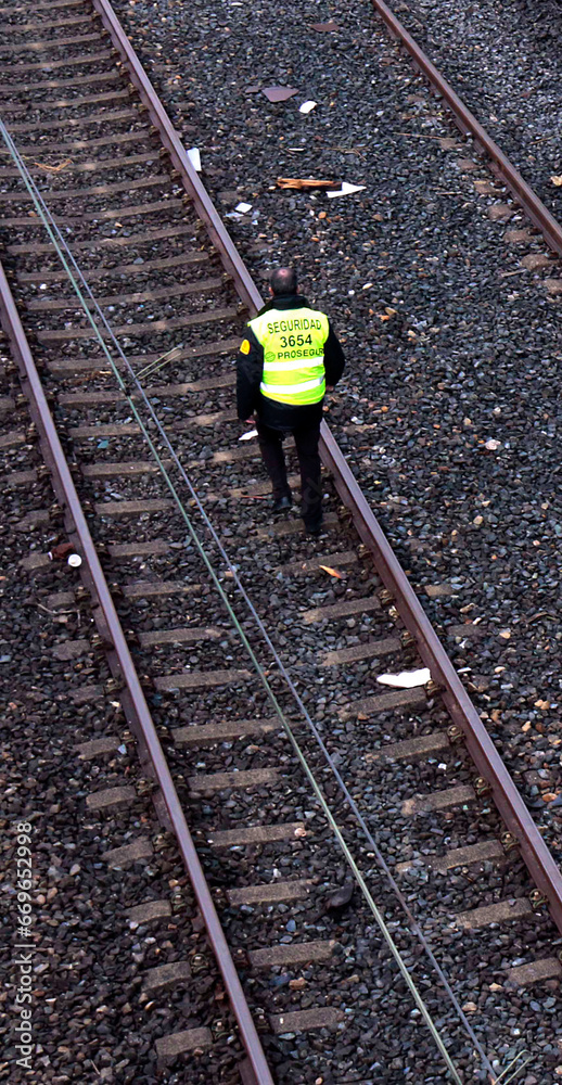 Train accident, security guard checking train tracks, dirty rails ...