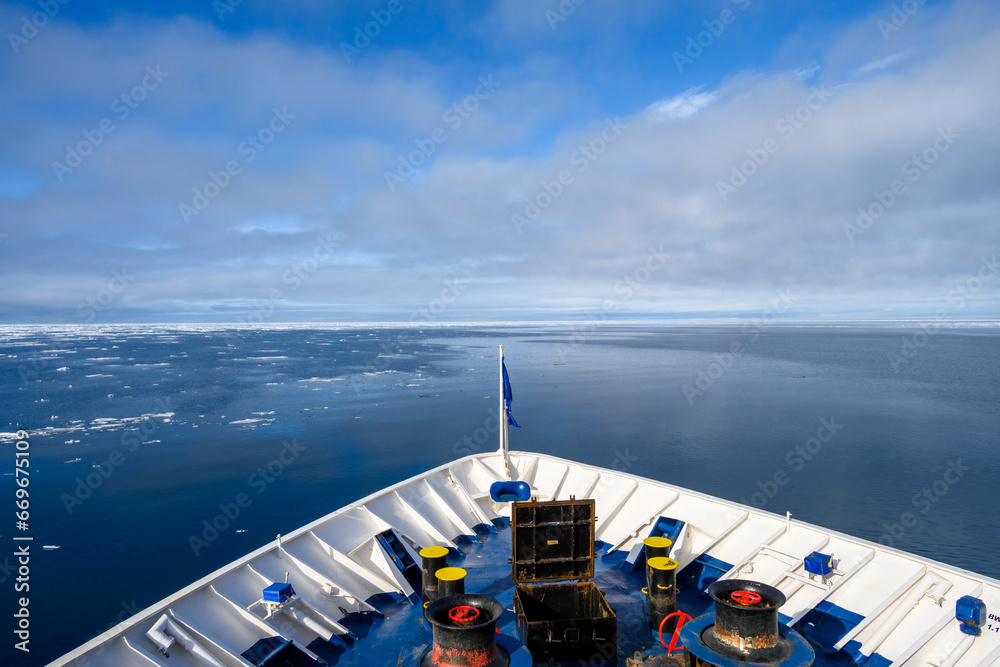 Bow of an arctic cruise ship on a sunny day in the high arctic, melting ...