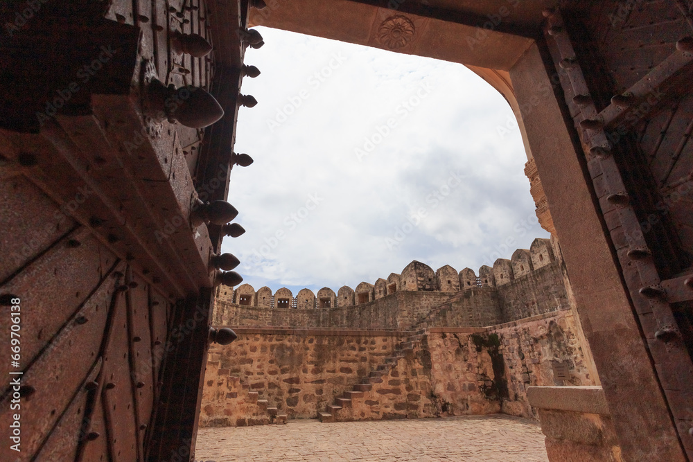 Massive iron gate of the fort. Architectural view of Golconda fort in ...