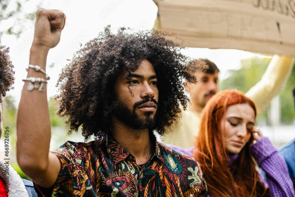 Emotional black activist on the street, chanting slogans and raising ...