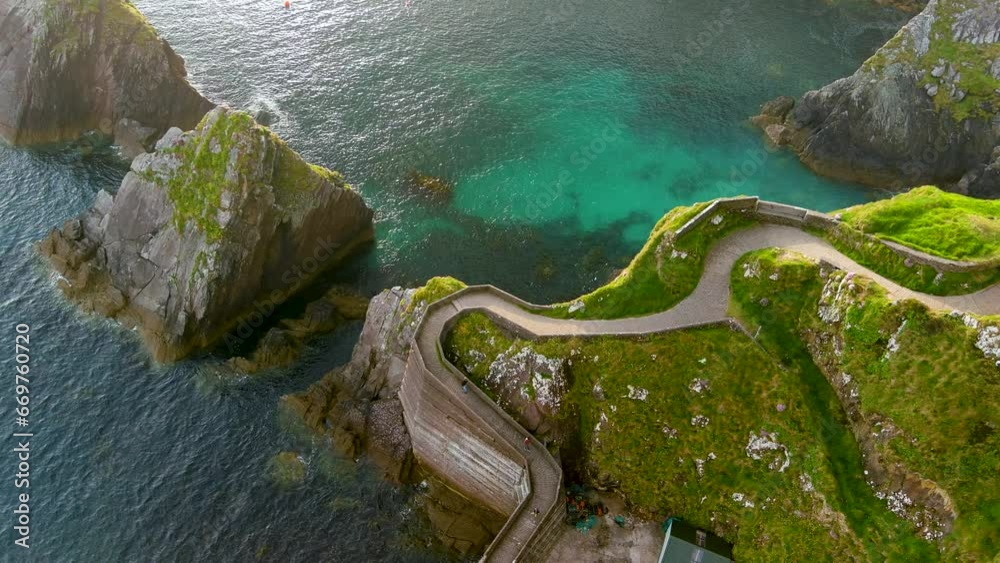 Dunquin or Dun Chaoin pier, Ireland's Sheep Highway. Aerial view of narrow pathway winding down ...