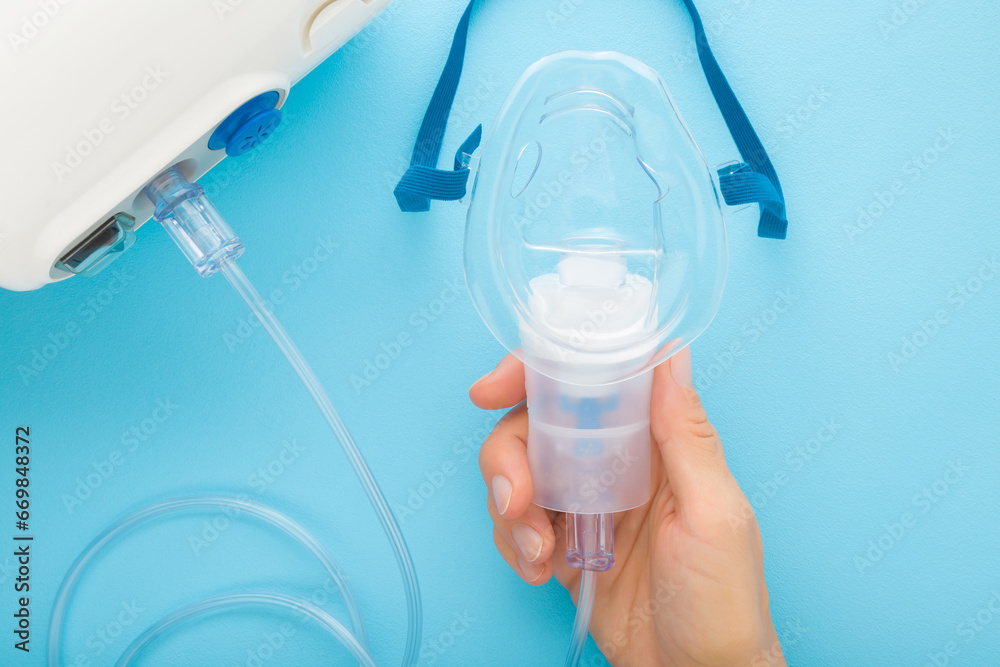 Young adult woman hand holding mask with container for drug breathing ...