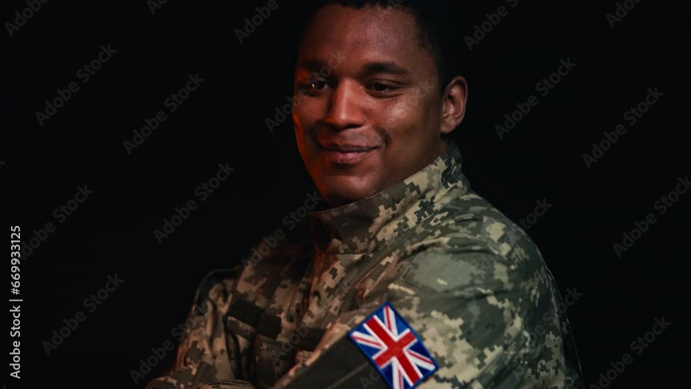 British soldier smiling crossing arms on chest, UK patch on military ...