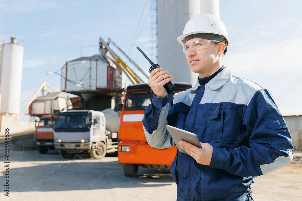 Banner cement plant or concrete factory. Engineer man in uniform with ...
