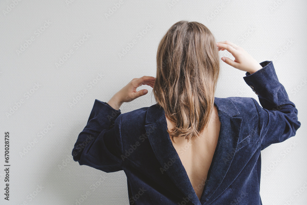 Brunette teenage girl wearing navy blue blazer backwards in front of ...