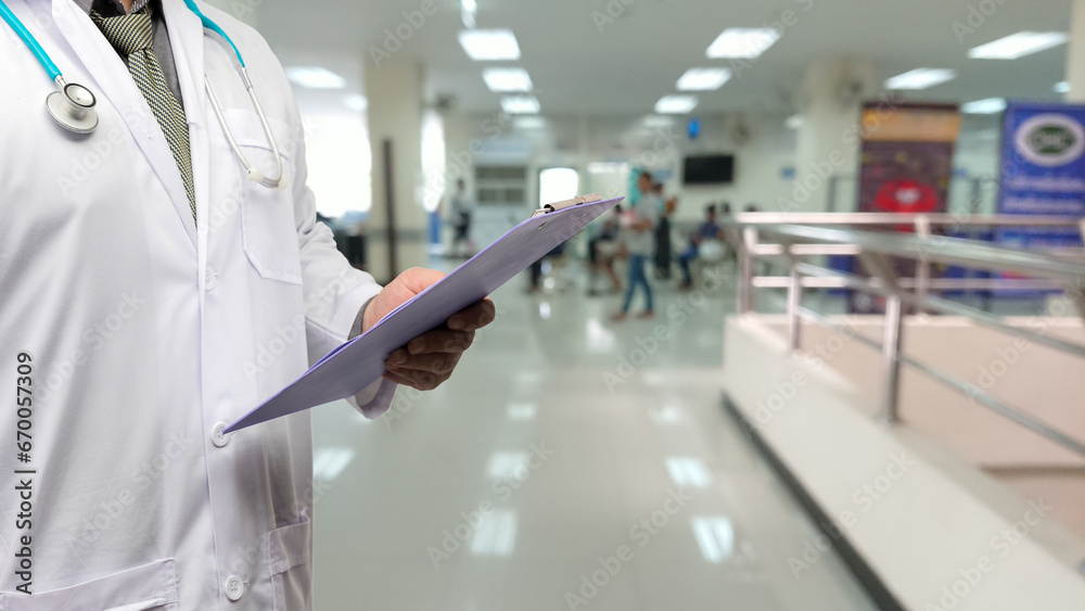 Doctor in gown uniform with patient chart standing on patient screening ...