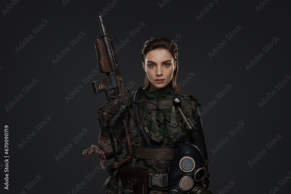 Portrait of a female soldier in military attire, holding a homemade ...