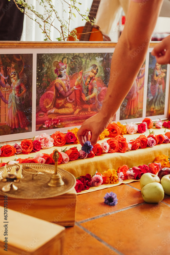 Preparing a colourful Hindu altar with offerings for a kirtan ...