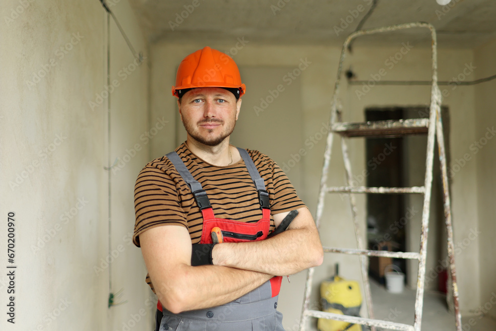 Renovation apartment. Portrait of young confident male foreman ...