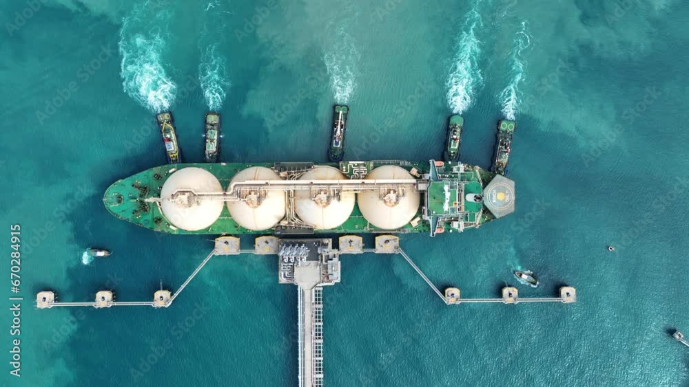 LNG (Liquefied natural gas) tanker anchored in Gas terminal gas tanks ...