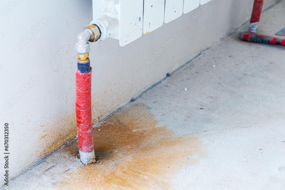 Radiator pipe wrapped in red electrical tape, heating leak, rusty ...