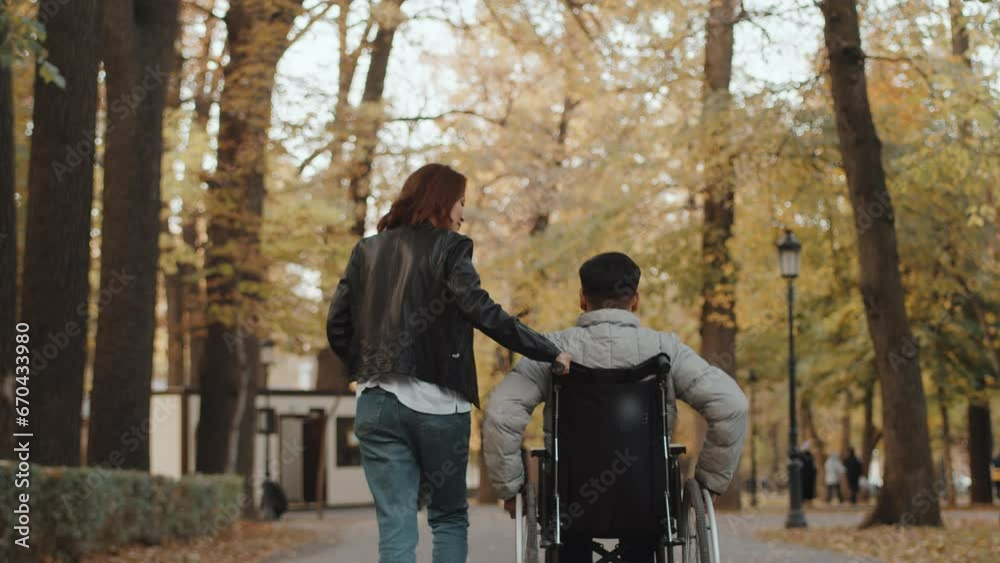Disabled man pushing the wheels of a wheelchair with his own hands and ...
