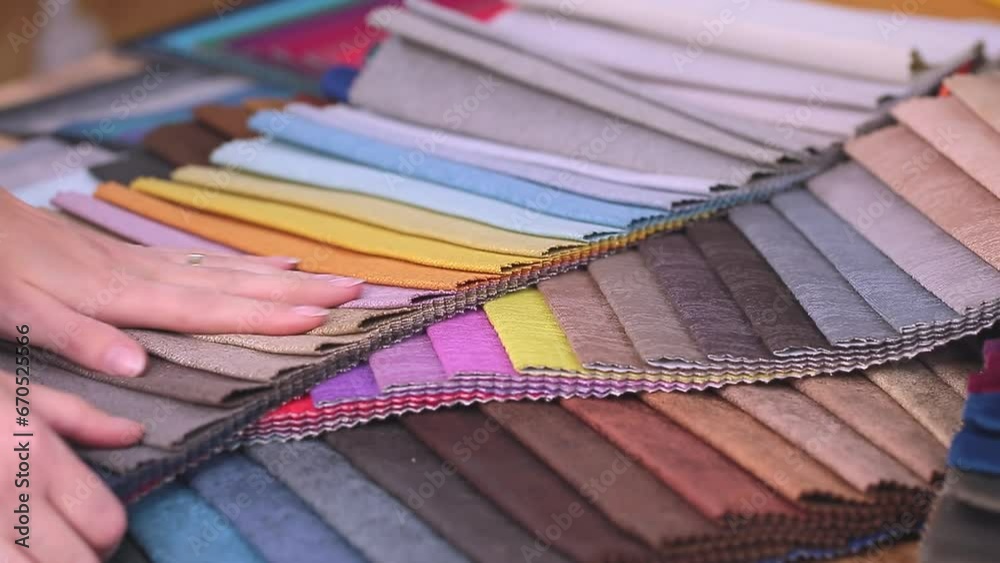 Fabric swatches in different colors are stacked for selection. The ...