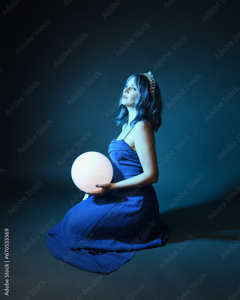 Full length portrait of beautiful female model wit blue hair wearing ...